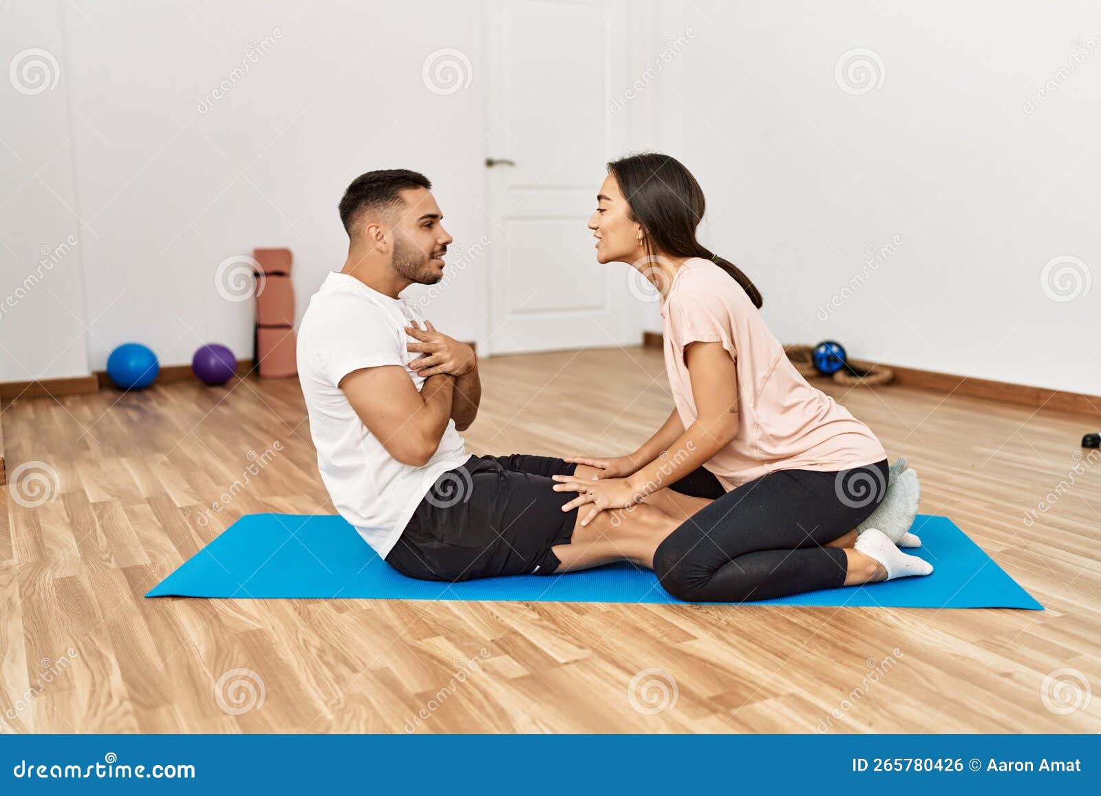 Latin Man And Woman Couple Smiling Confident Training Abs Exercise At