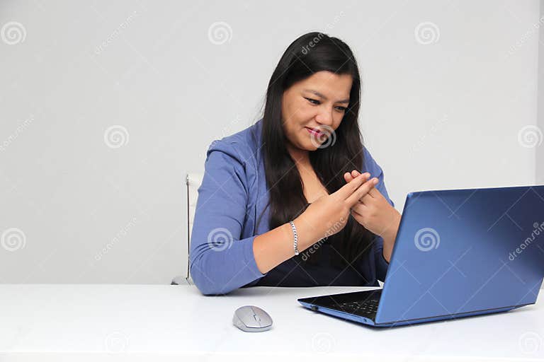 Latino Adult Woman Speaks Mexican Sign Language With A Deaf Person Through A Laptop In A Video