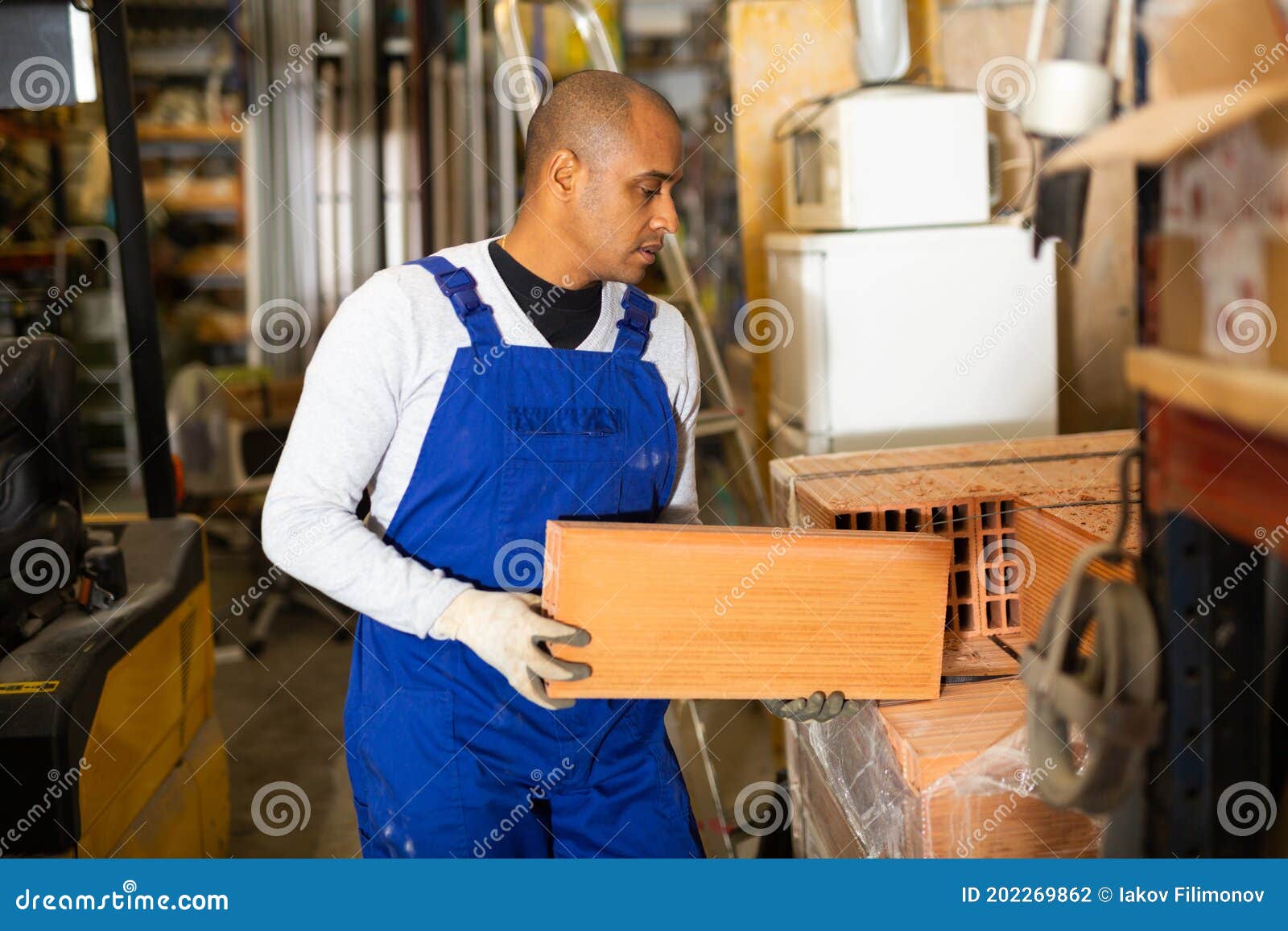 Latino in Blue Coverall Arranging Bricks in Construction Hypermarket ...