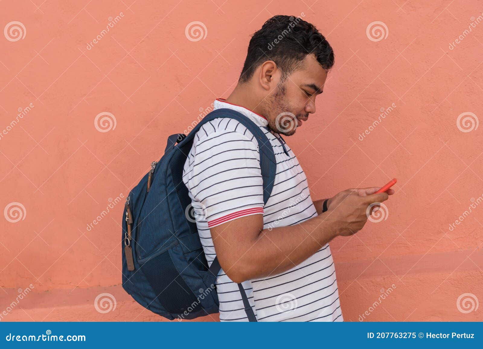 A Latino Man Checking His Phone on the Street Stock Image - Image of ...