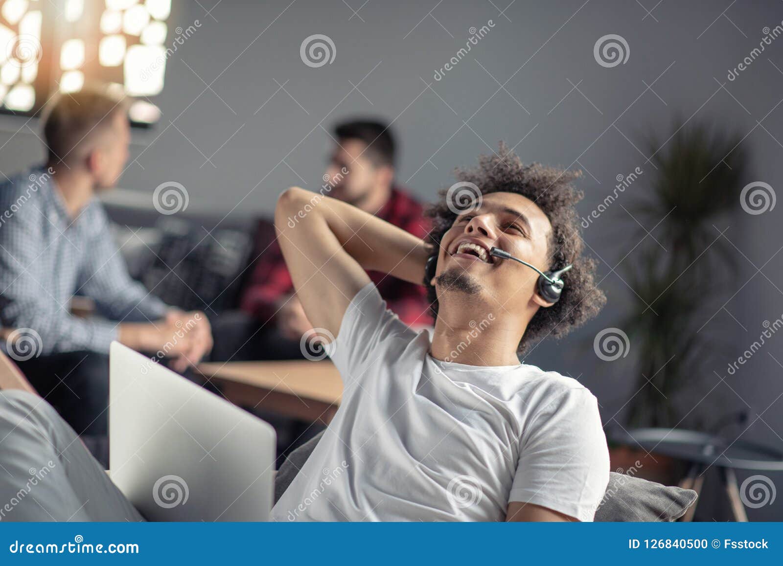Laughing African American Hipster Software Developer at Computer at Office of Startup Company ...