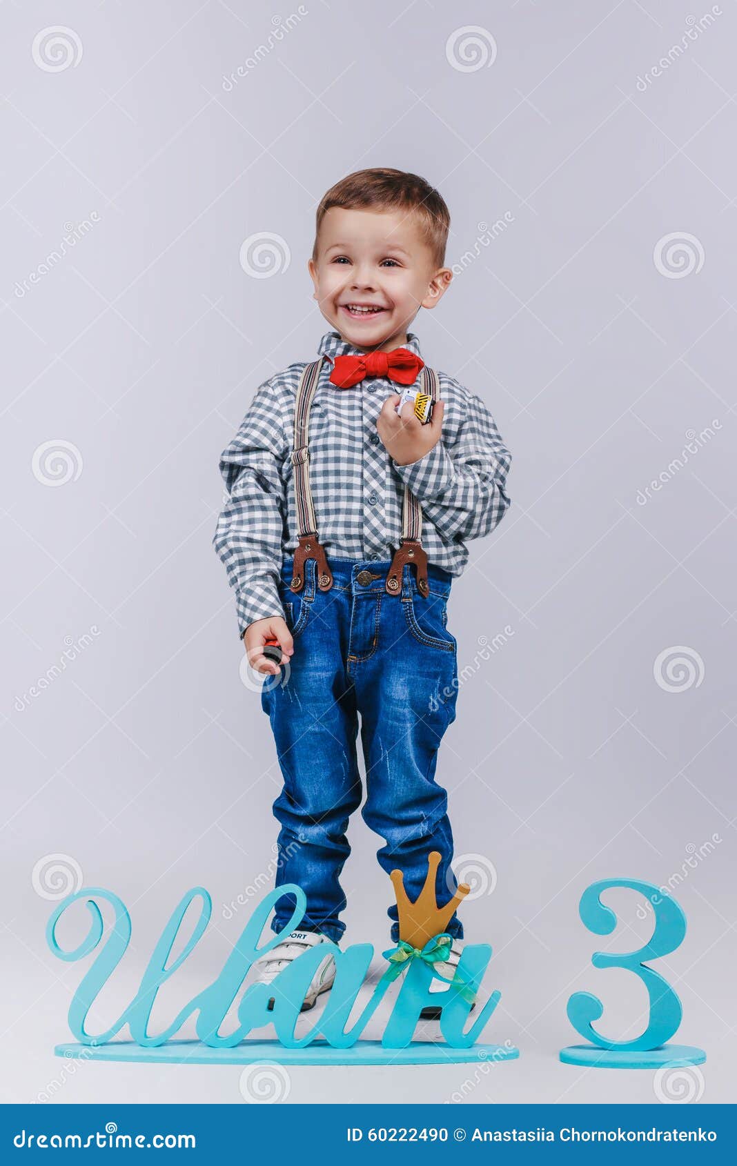 Laughing Boy in Blue Jeans with Braces on Grey Background Stock Photo ...