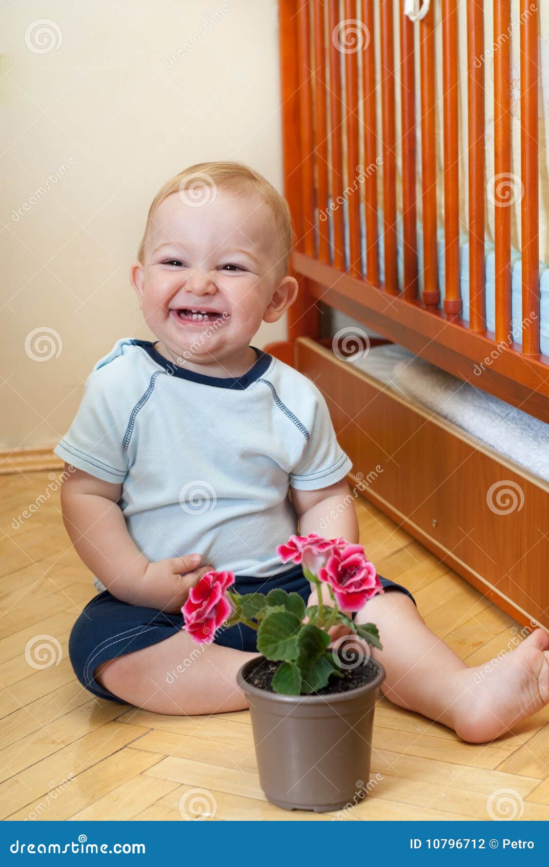Laughing boy with flower stock photo. Image of emotion - 10796712