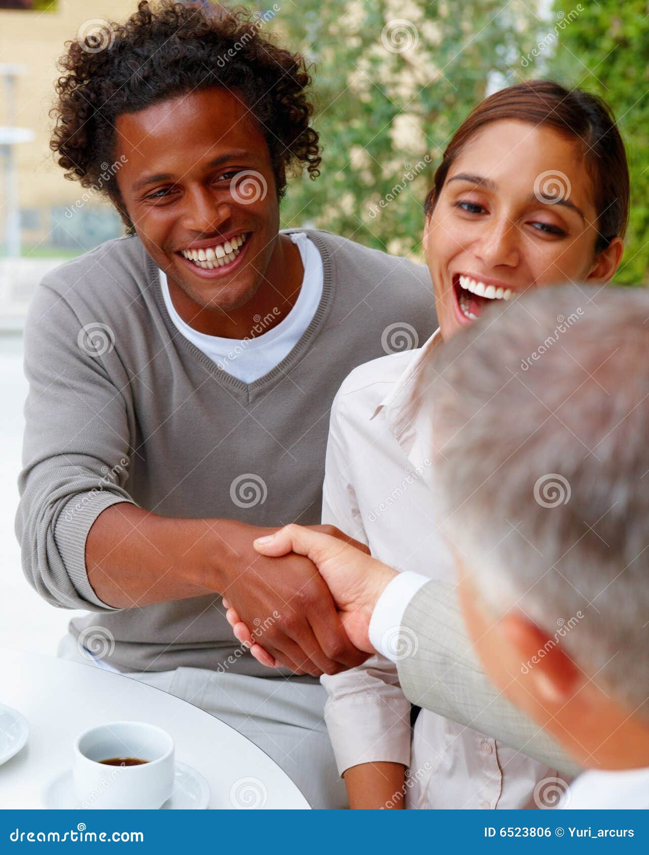 Laughing Business Colleagues Shaking Hands at Tabl Stock Photo - Image ...