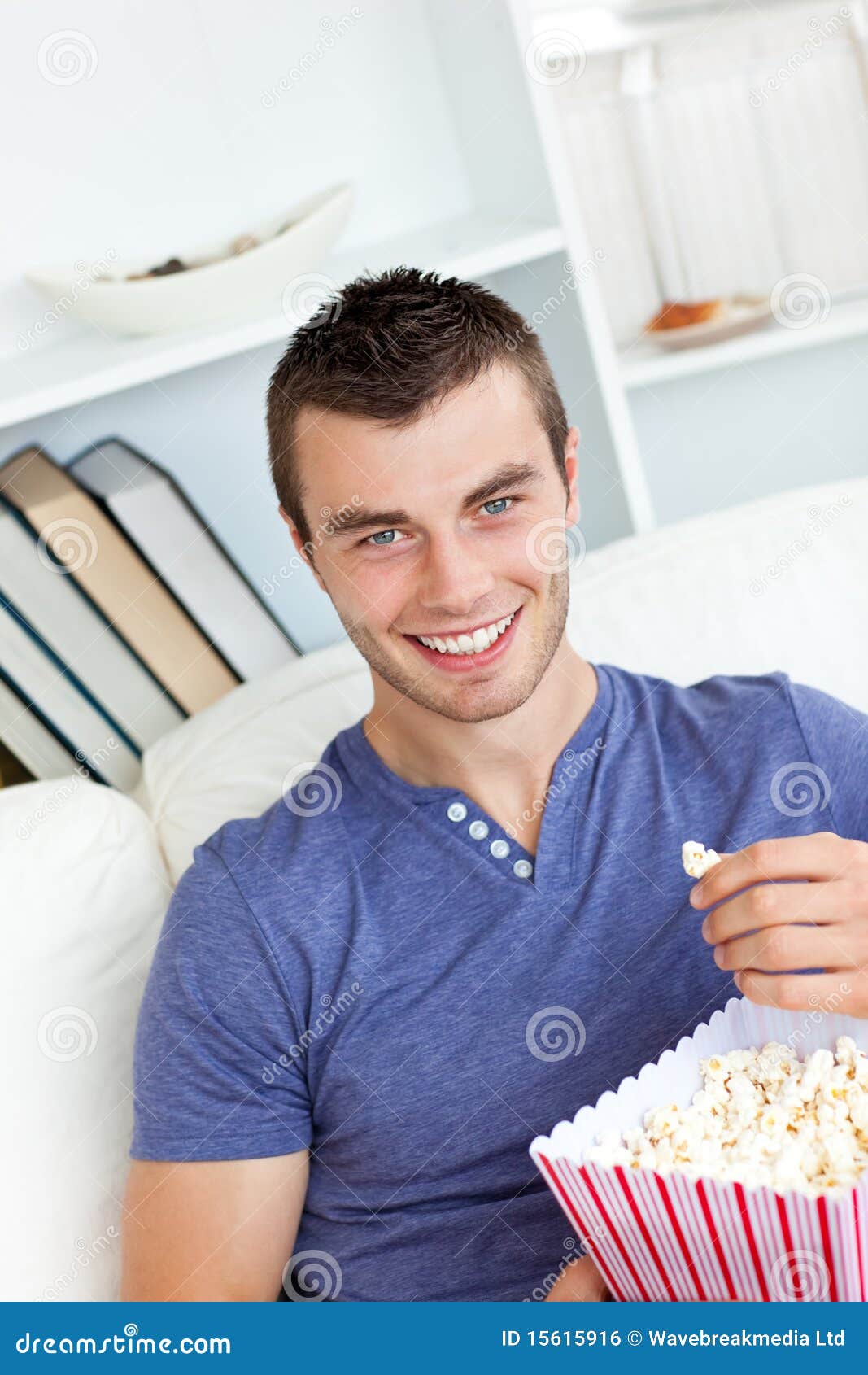 Laughing Caucasian Man Eating Popcorn on the Sofa Stock Photo - Image ...