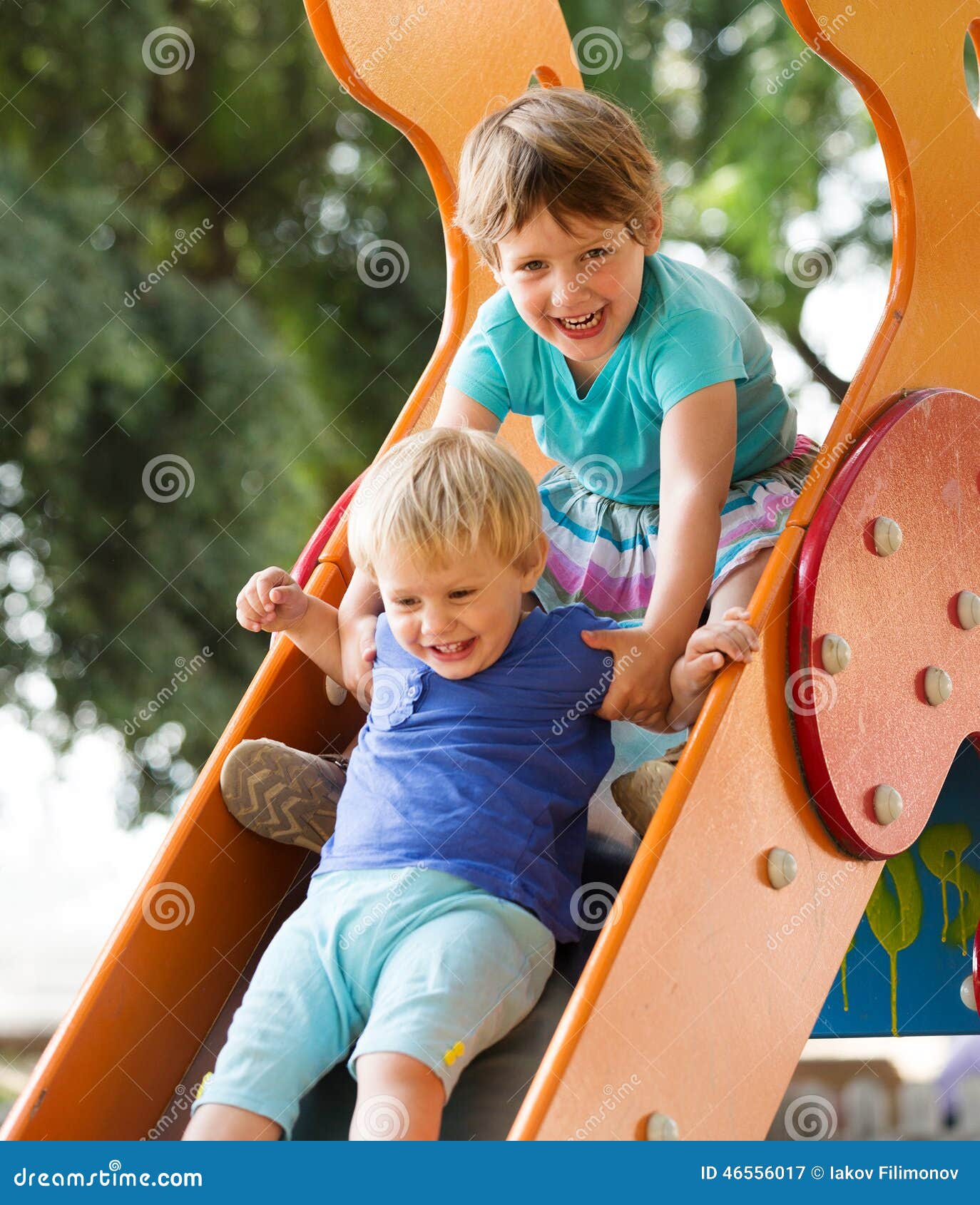 Laughing children on slide stock image. Image of daughter - 46556017