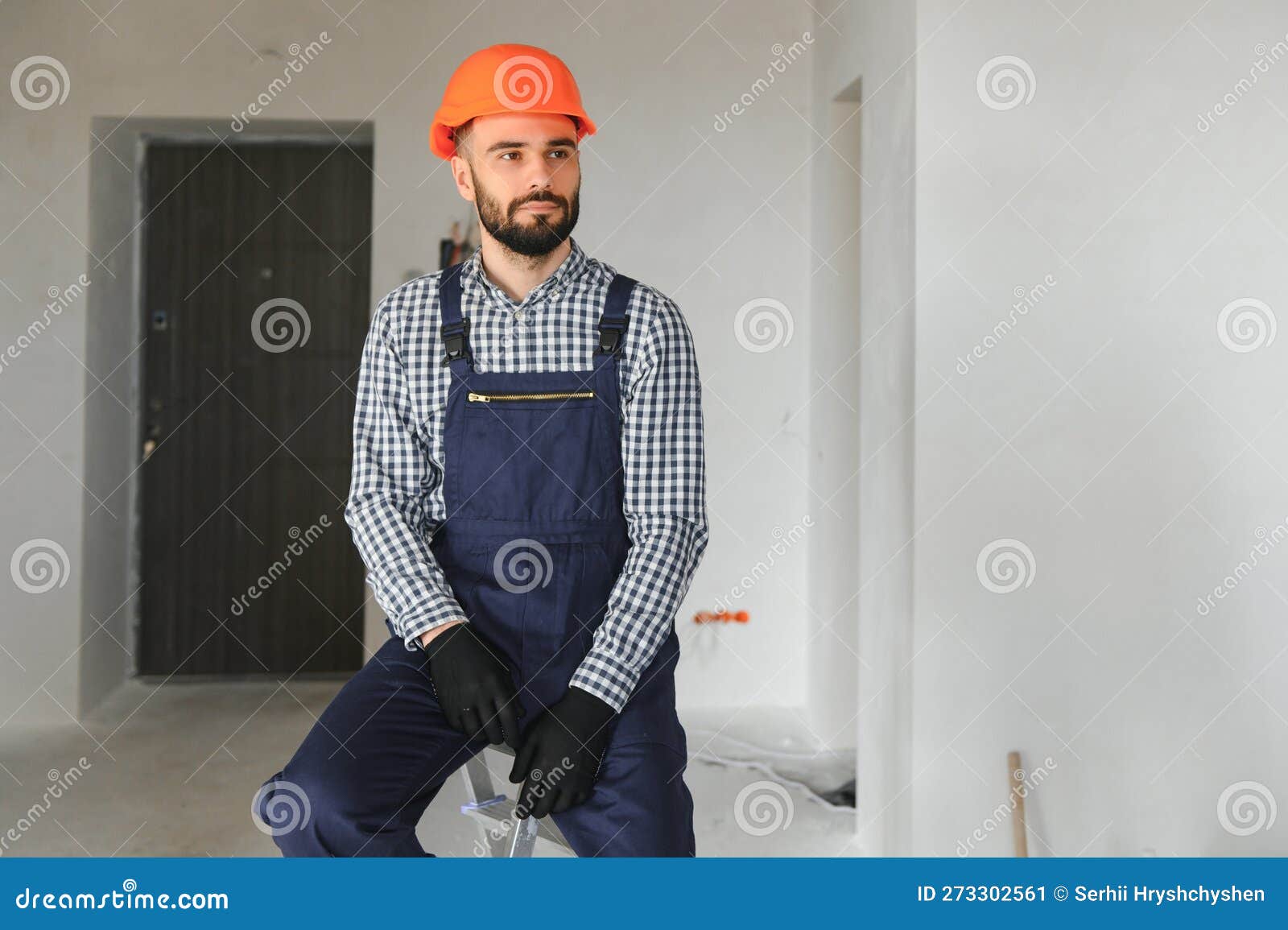 Laughing Construction Worker on the Background of a Gray Concrete Wall ...