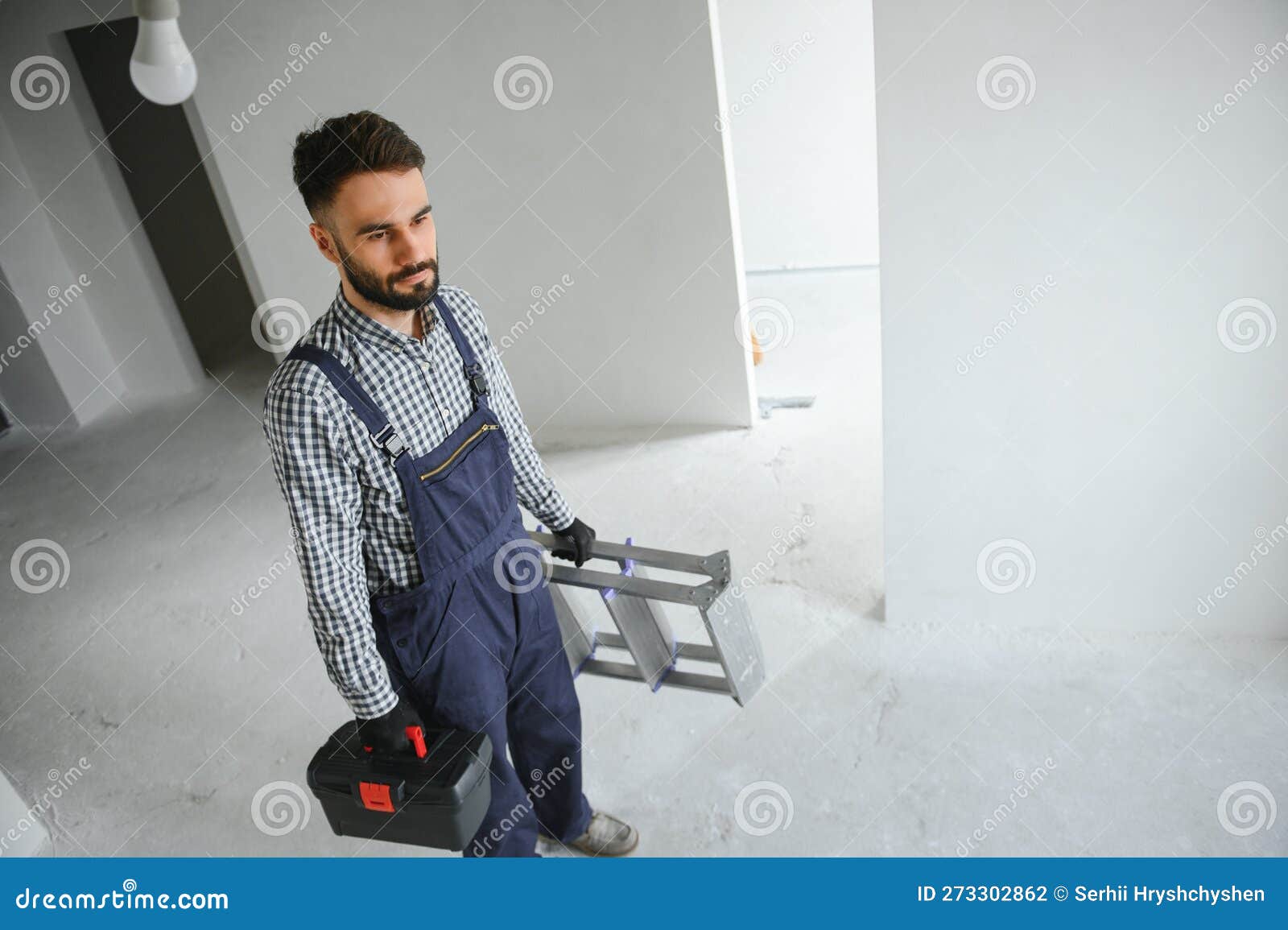 Laughing Construction Worker on the Background of a Gray Concrete Wall ...
