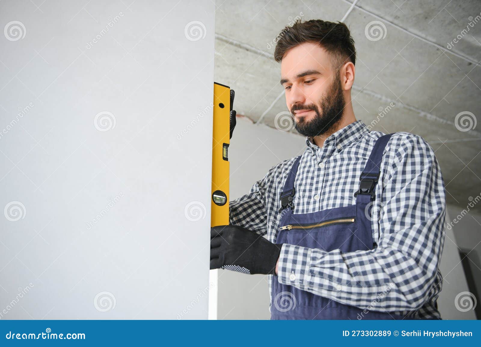 Laughing Construction Worker on the Background of a Gray Concrete Wall ...