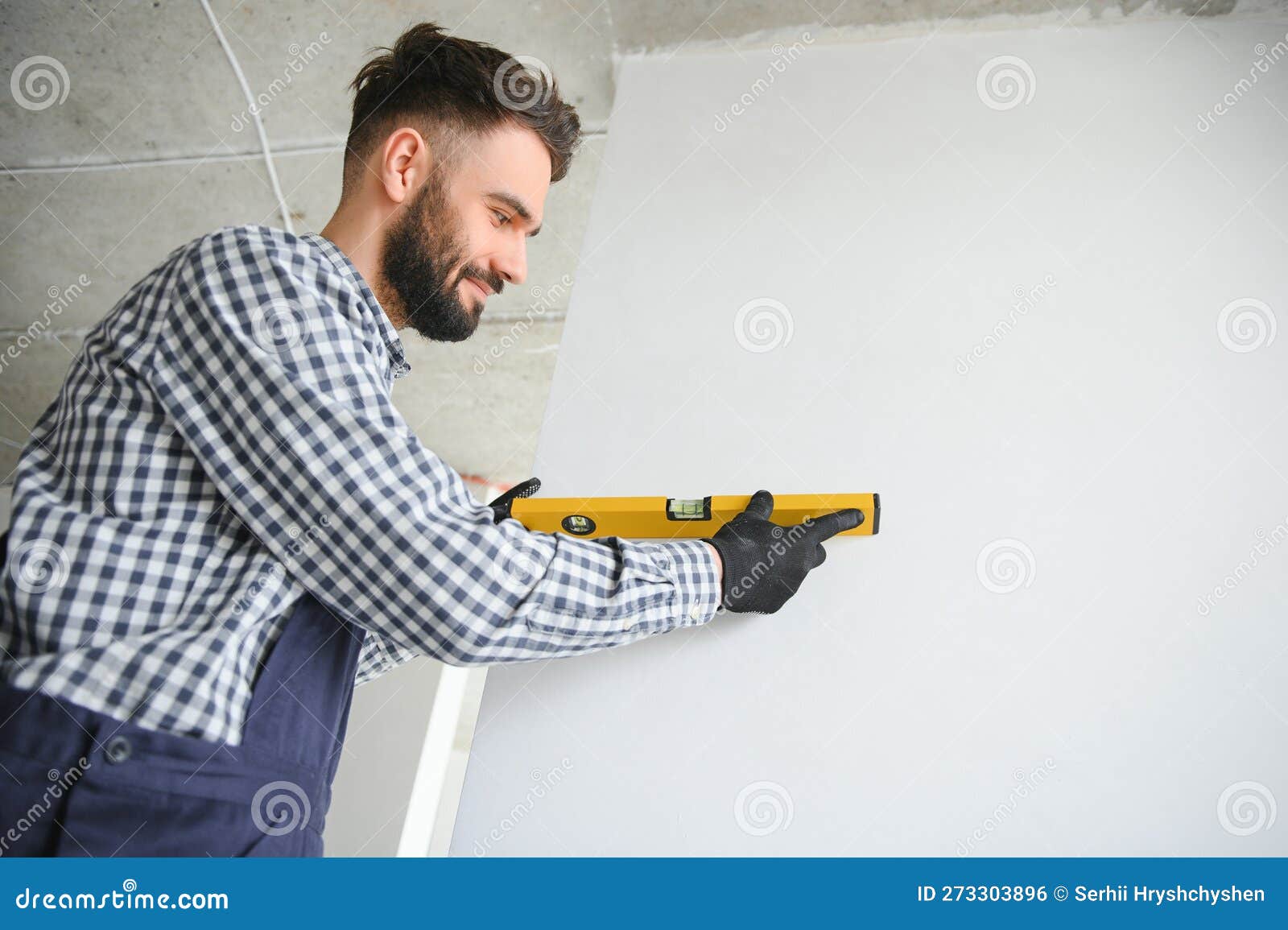 Laughing Construction Worker on the Background of a Gray Concrete Wall ...
