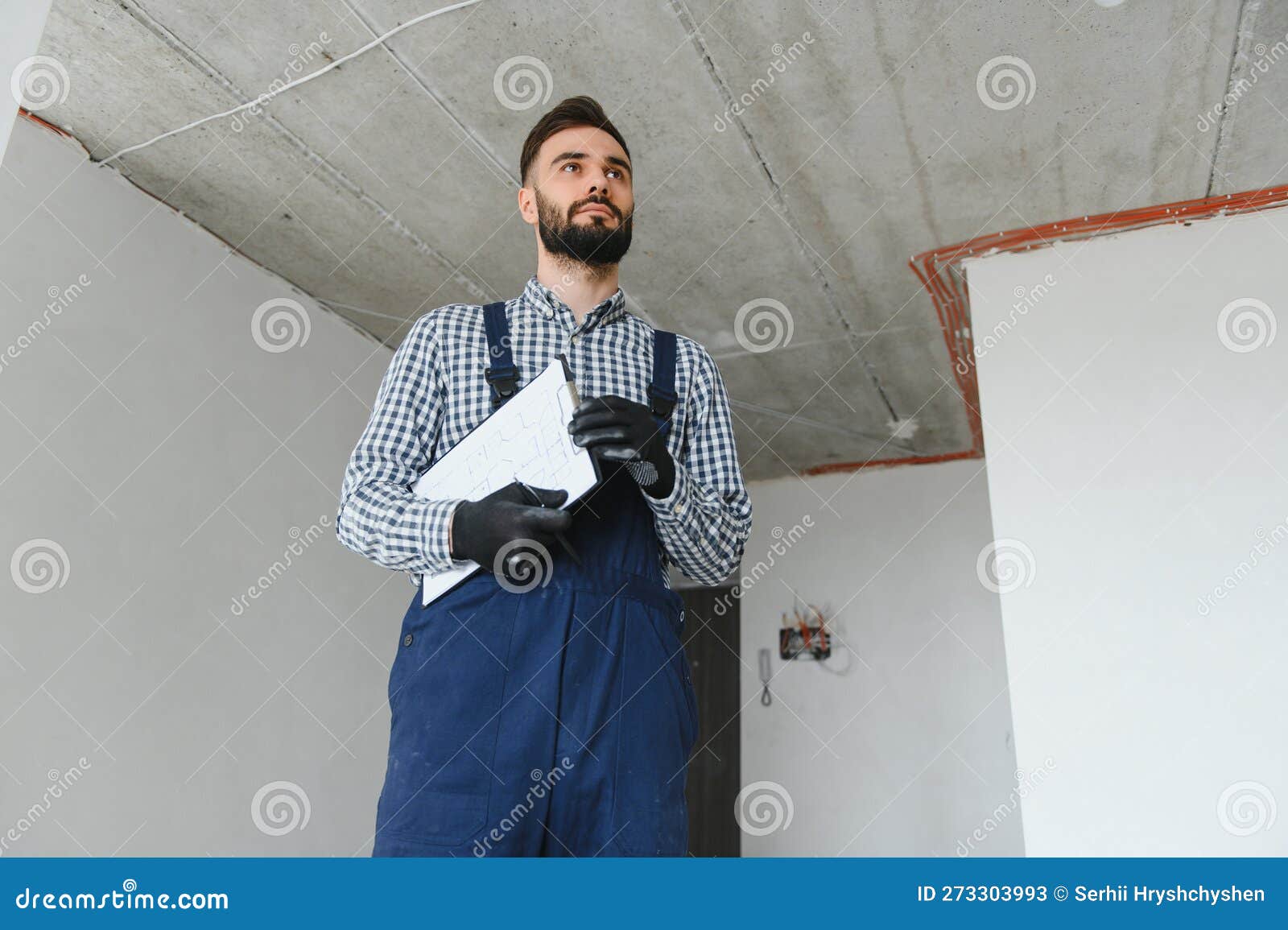 Laughing Construction Worker on the Background of a Gray Concrete Wall ...