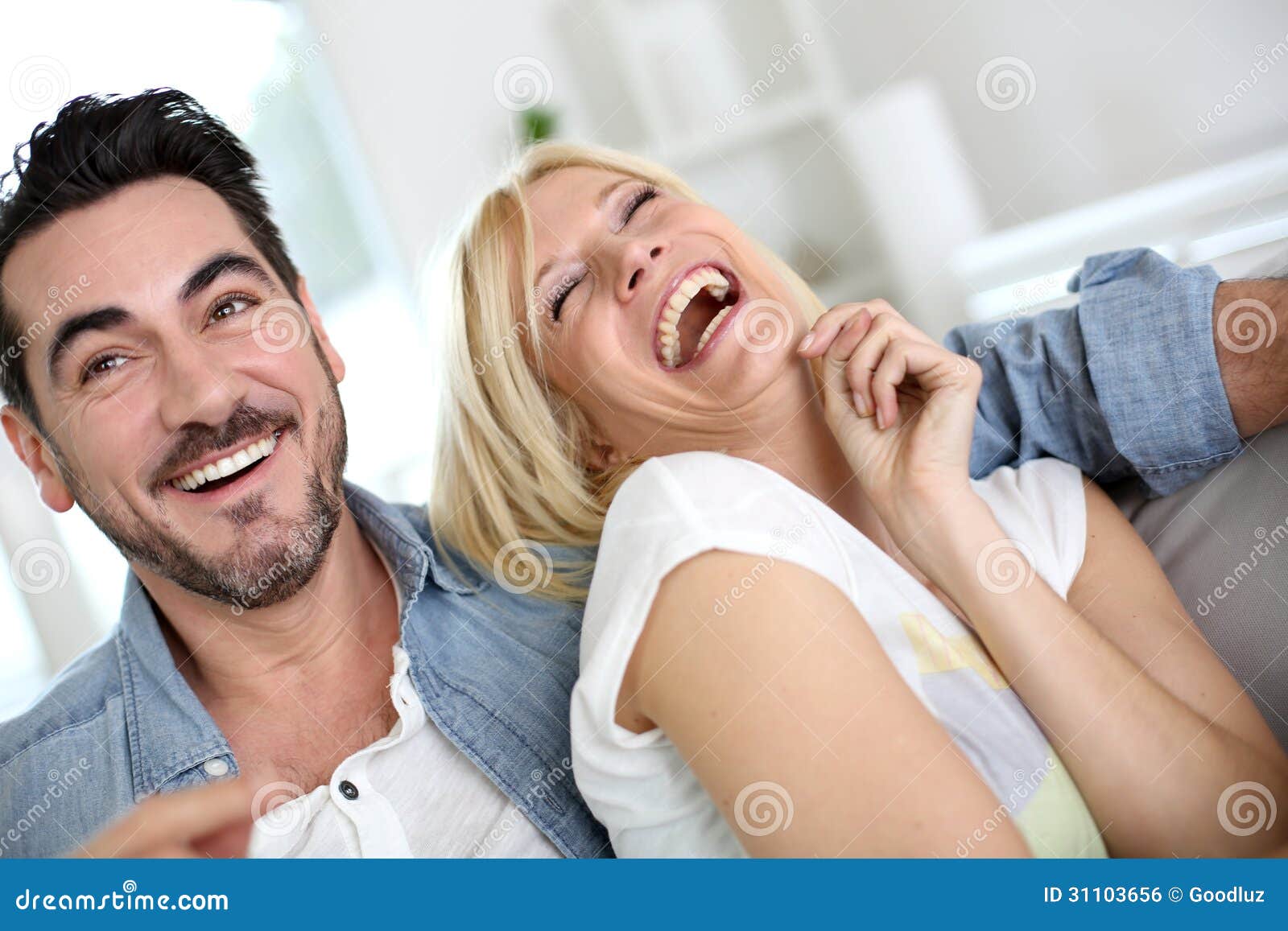 Laughing couple at home stock photo. Image of couple - 31103656
