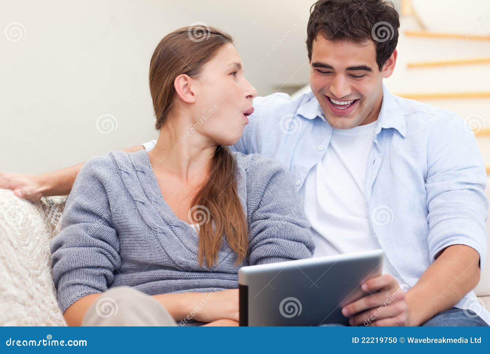 Laughing Couple Using a Tablet Computer Stock Photo - Image of home ...