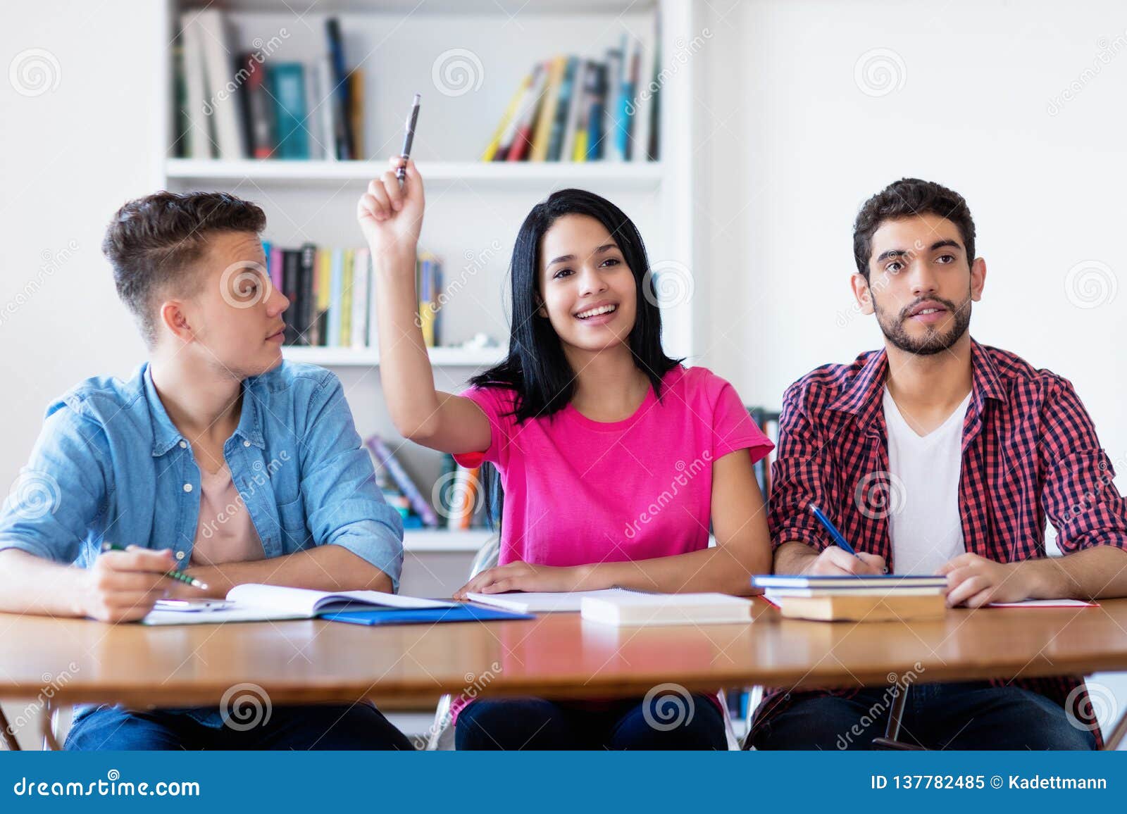Laughing Female Student Raising Hand in Classroom Stock Image - Image ...