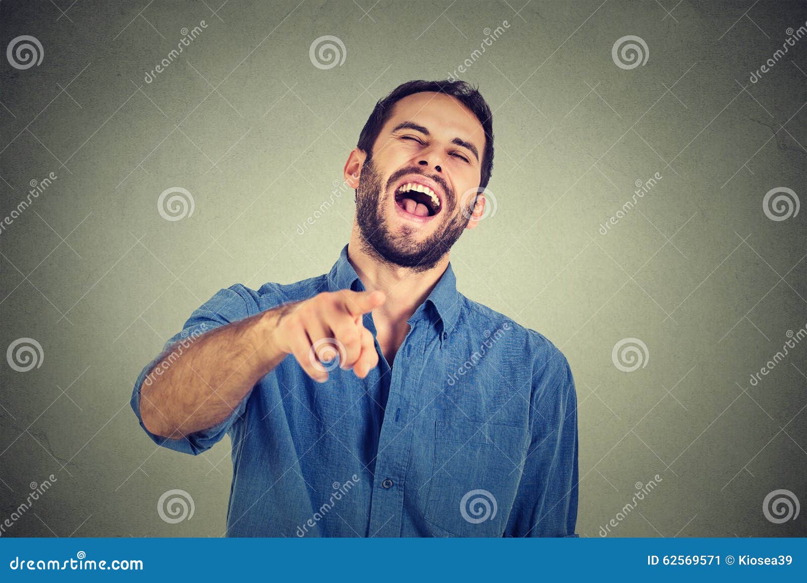 Laughing Guy Pointing with Finger at Camera Stock Image - Image of gray ...