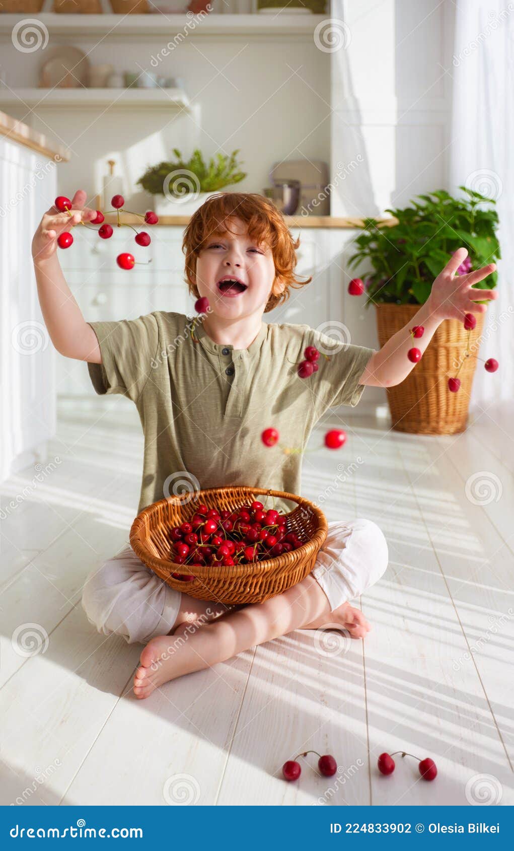 Laughing Kid Playing with Cherries, Throwing Berries at the Floor on ...
