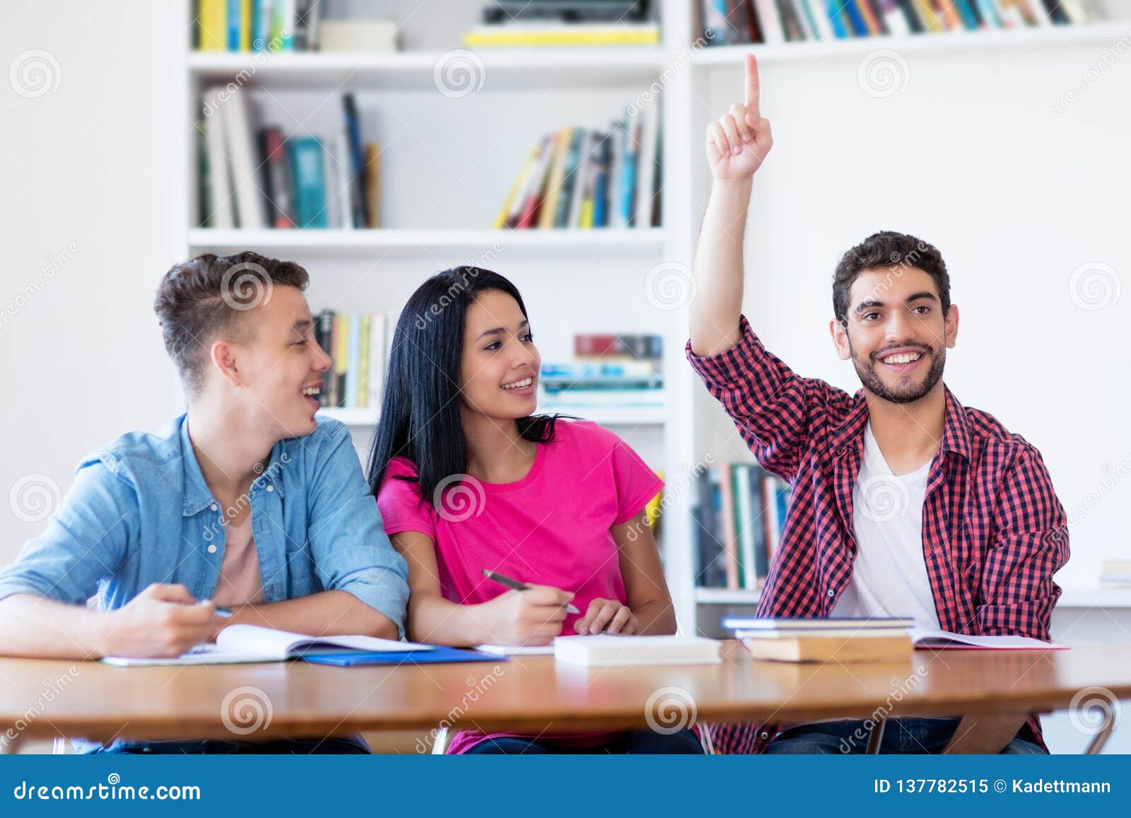 Laughing Male Student Raising Hand in Classroom Stock Image - Image of ...