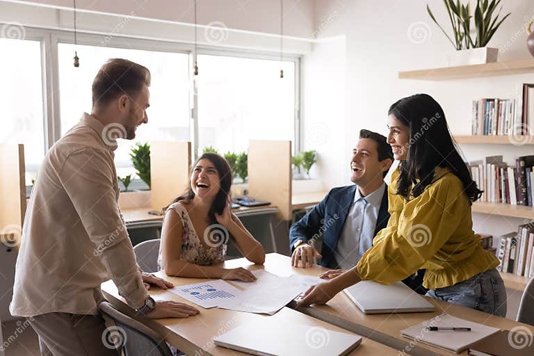 Laughing Polyethnic Young People Team Doing Paperwork at Creative ...