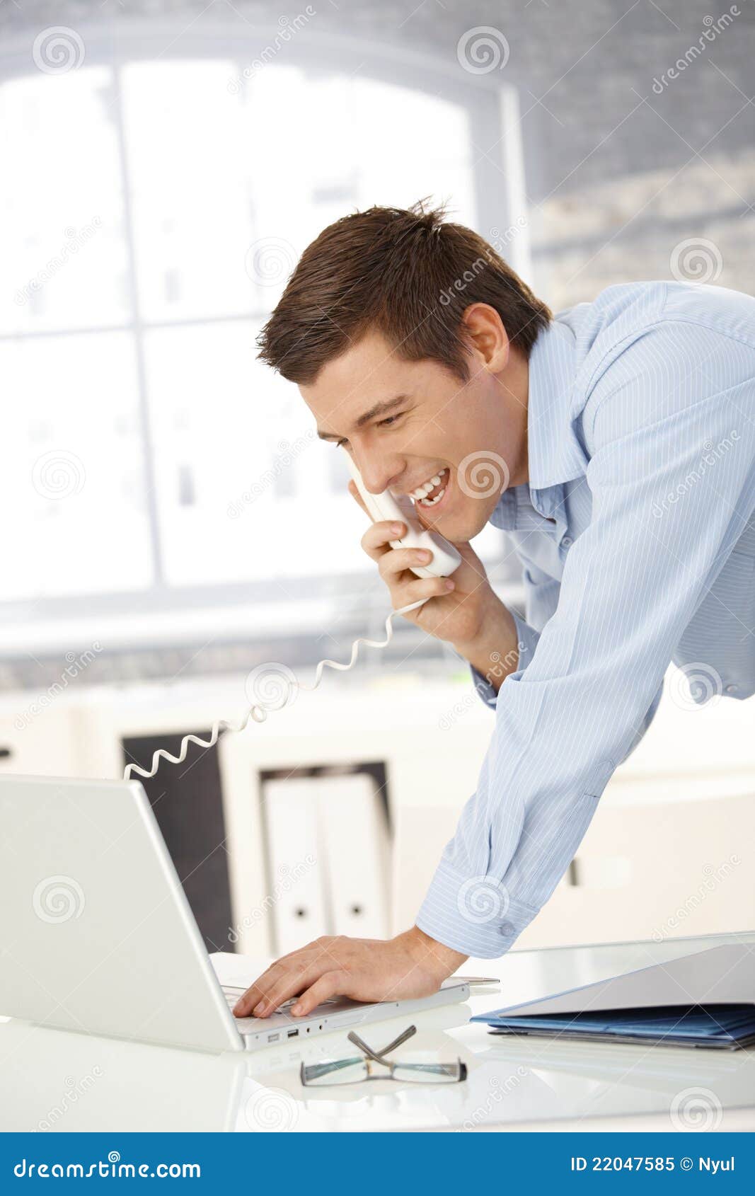 Laughing Professional on Landline Call with Laptop Stock Image - Image ...