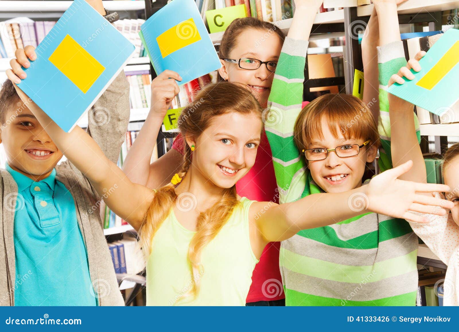 Laughing Pupils with Exercise Books Up in Library Stock Photo - Image ...