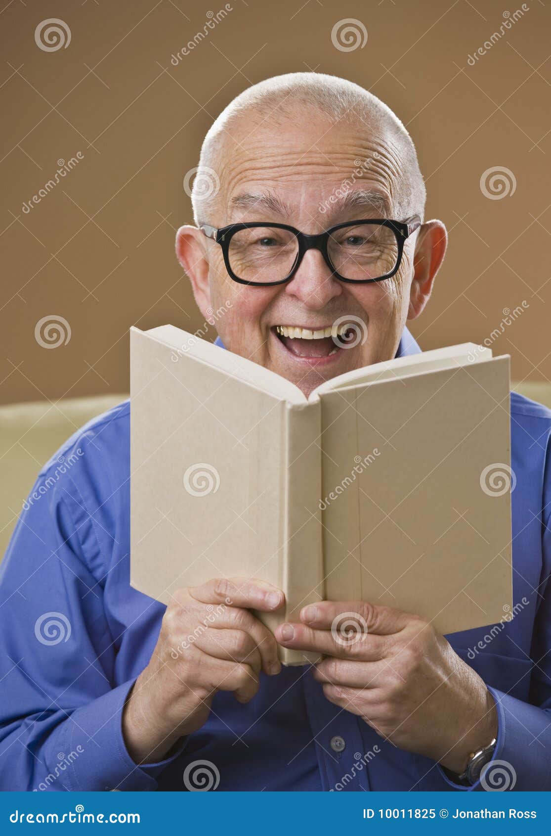 Laughing Senior Male Reading a Book Stock Image - Image of clothing ...