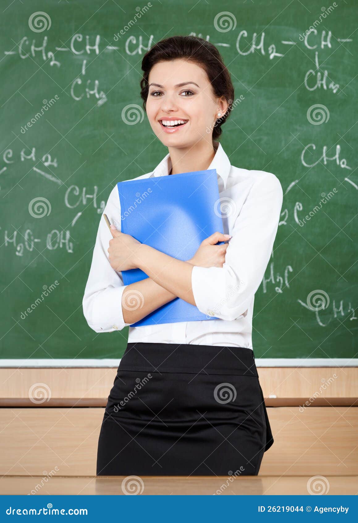 Laughing Teacher at the Blackboard Hands a Folder Stock Photo - Image ...