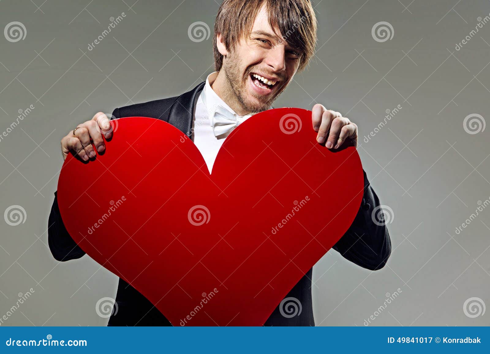 Laughing Young Man Holding a Heart Stock Image - Image of celebrating ...