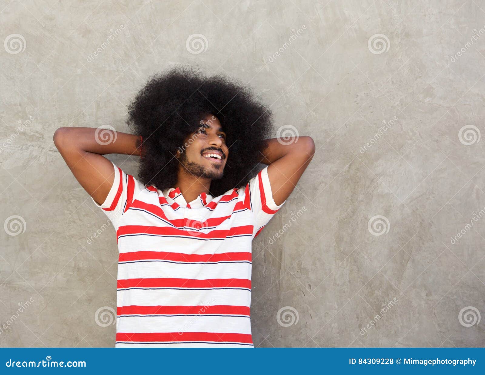 Laughing Young Man Standing with Hands Behind Head Stock Photo - Image ...