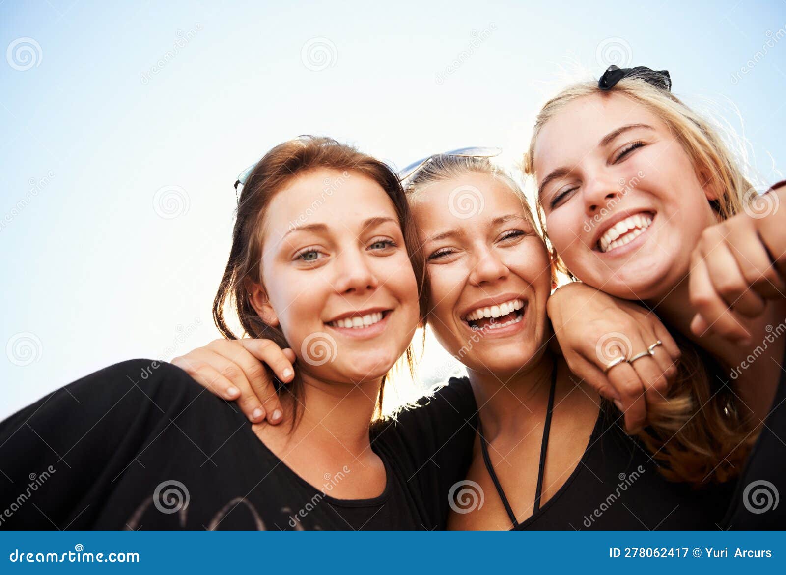 Laughter and Happiness. Three Friends Hugging and Smiling Against a ...