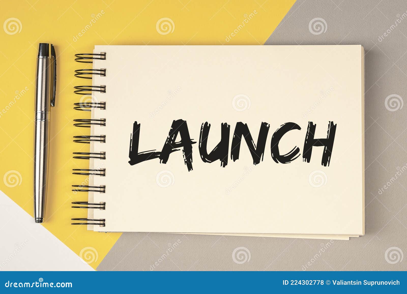 Launch Word on Notepad Paper on Yellow and Grey Background Stock Photo ...