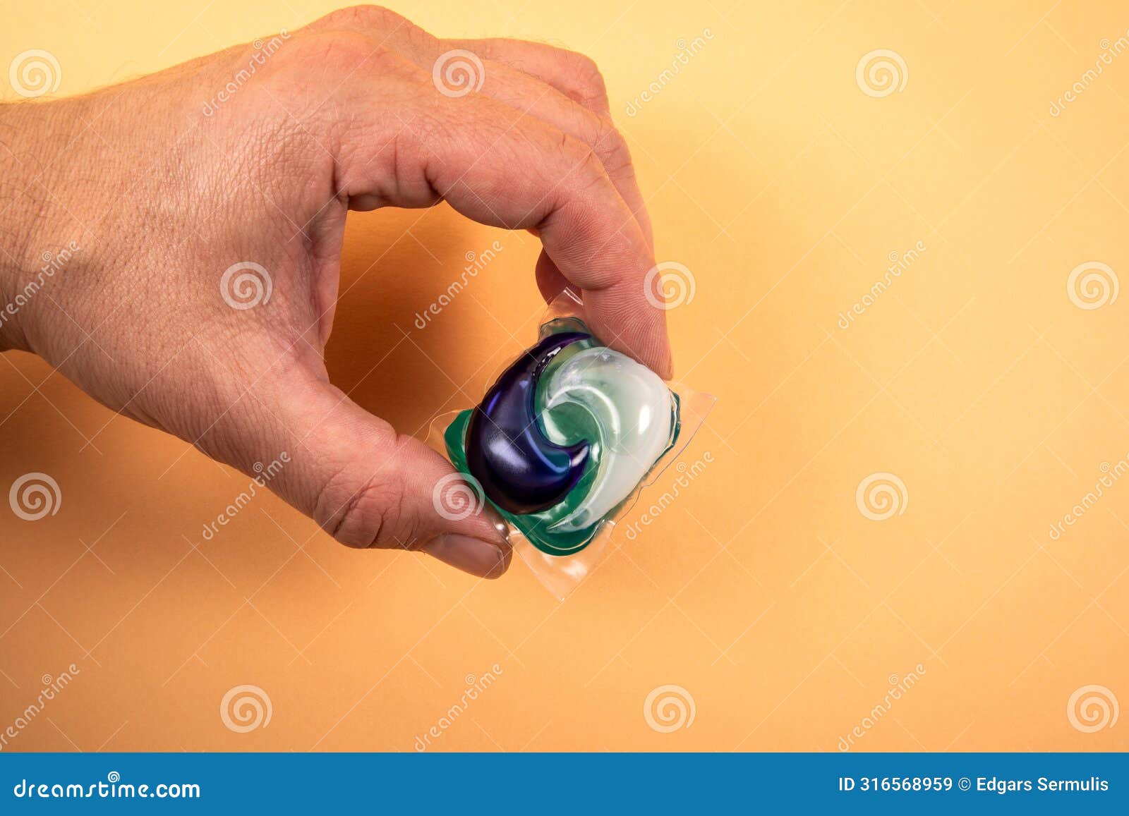 Laundry Capsule in Hand on Light Background Stock Image - Image of ...