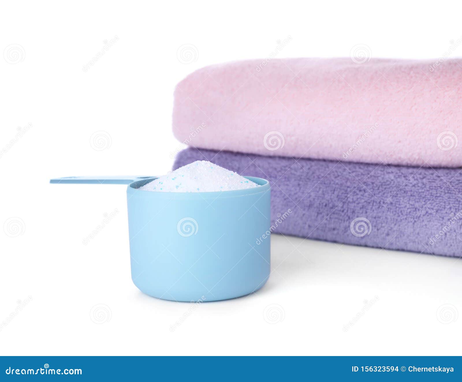 Laundry Detergent in Plastic Scoop and Towels on White Background Stock ...