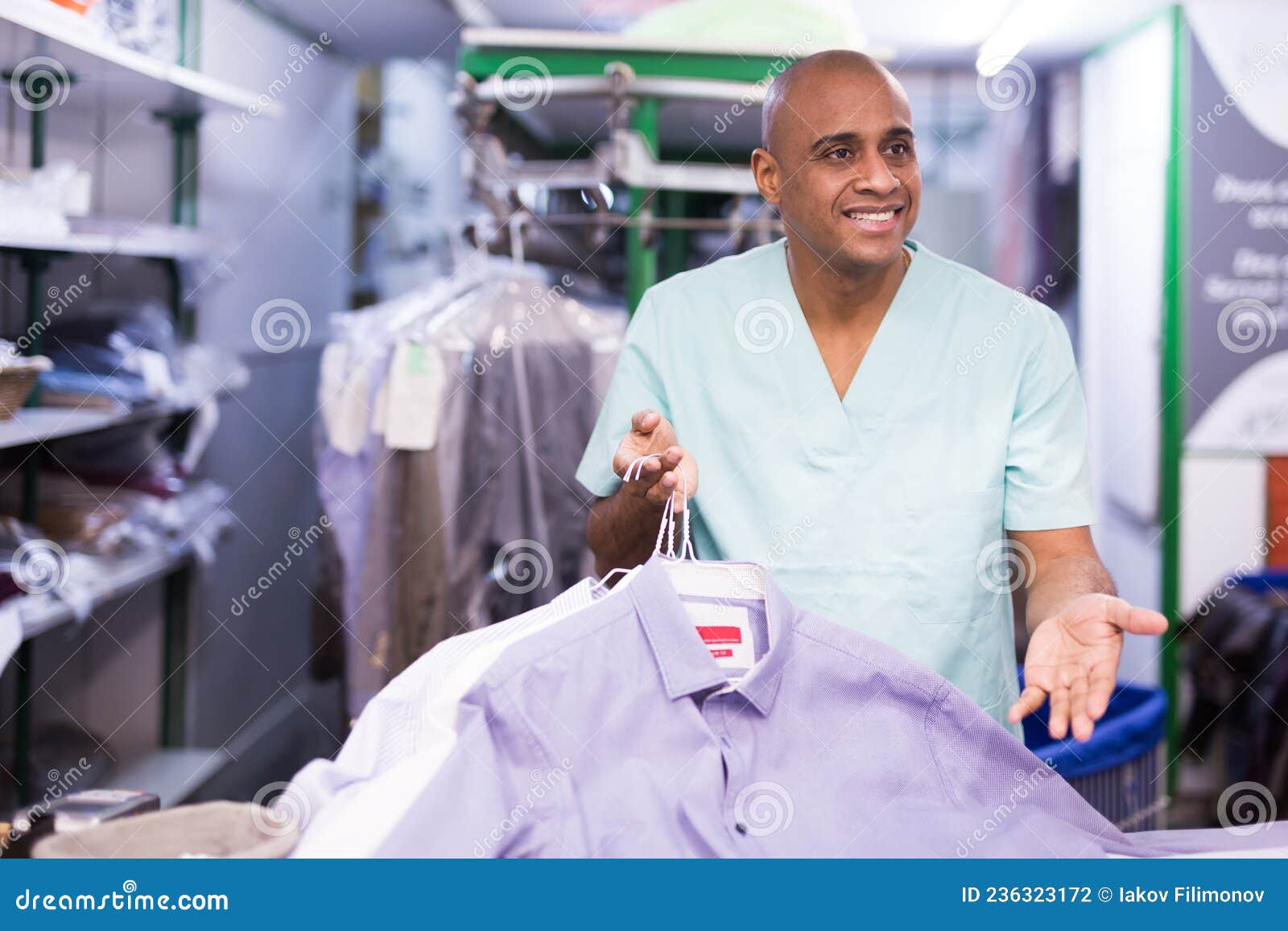 Laundry Male Worker Demonstrates Clean Clothes Stock Photo - Image of ...