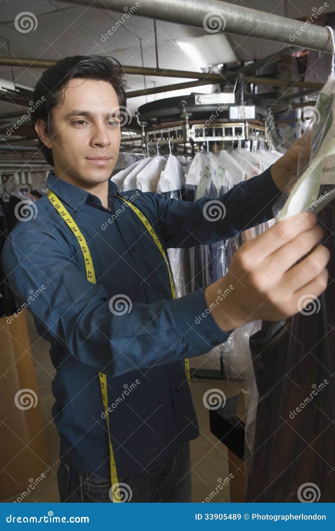 Laundry Owner Checking Clothes Stock Image - Image of male, hispanic ...