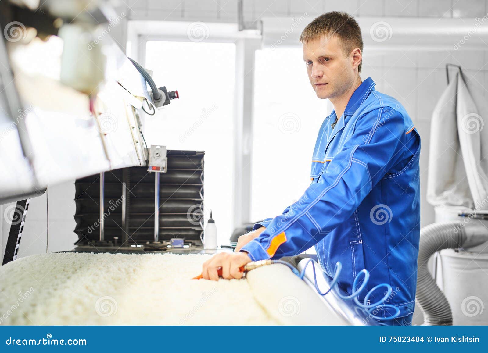 Laundry Worker in the Process of Working on the Automatic Machine for ...