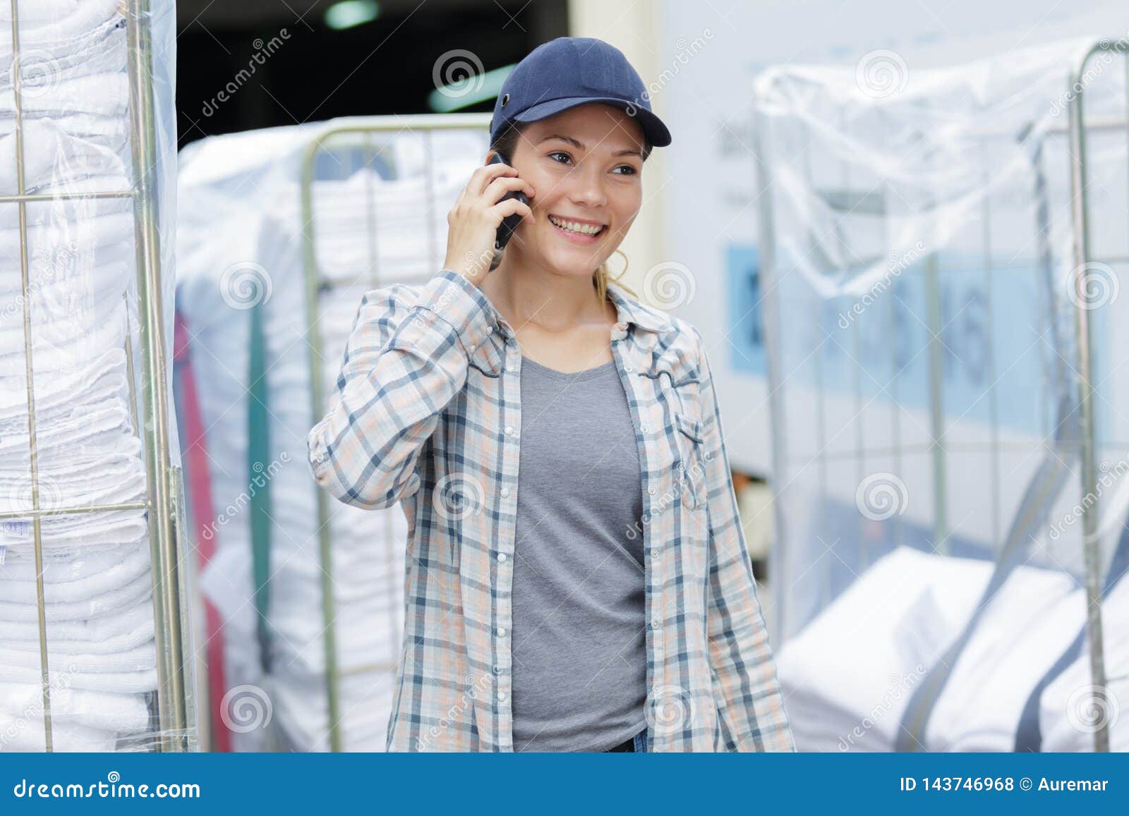 Laundry Worker Talking on Phone Stock Photo - Image of trolley, phone ...