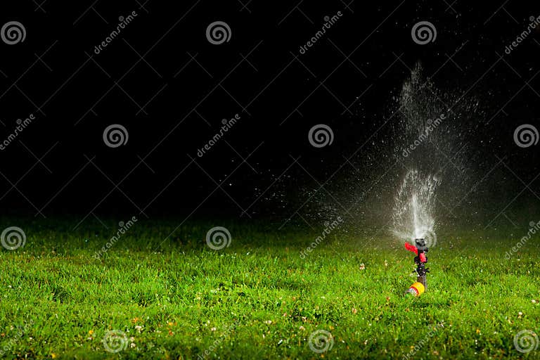 Lawn sprinkler at night stock photo. Image of nature - 18782062