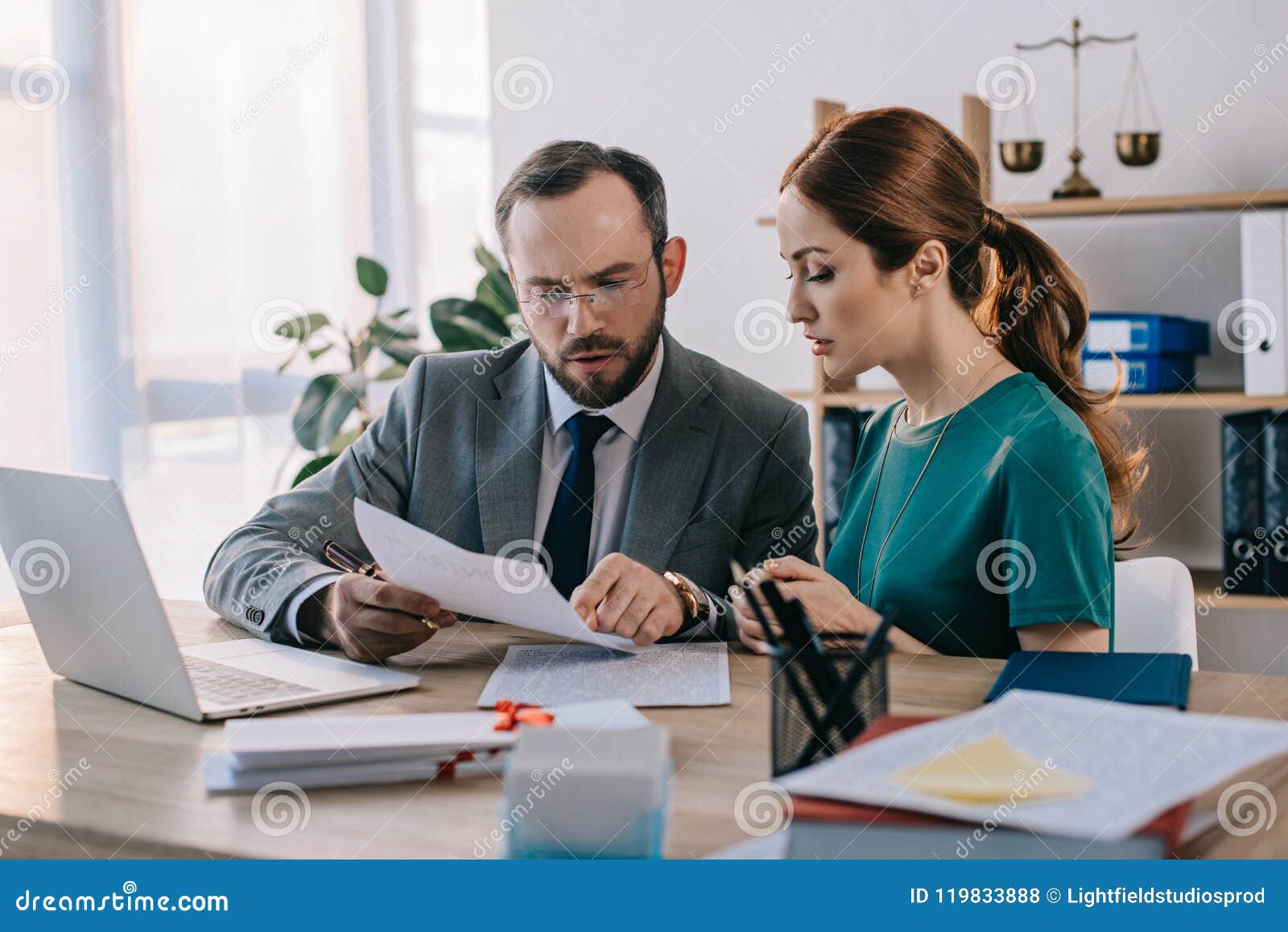 Lawyer and Client Discussing Contract at Workplace with Laptop Stock ...