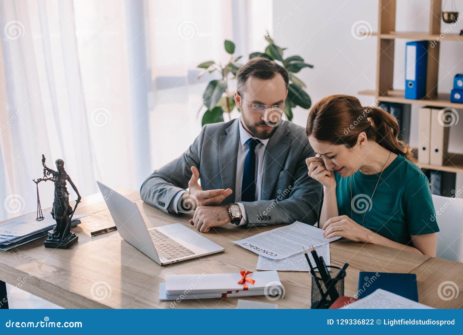 Lawyer and Client Discussing Contract at Workplace with Laptop Stock ...
