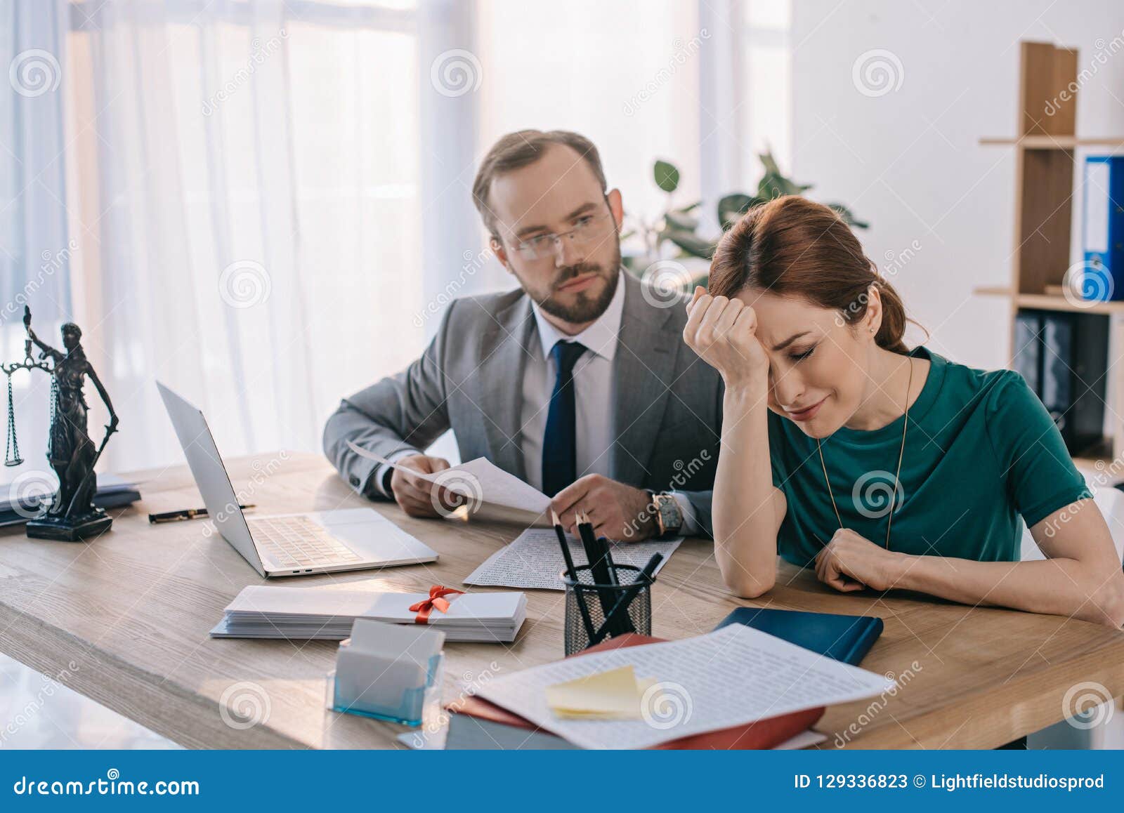 Lawyer and Client Discussing Contract at Workplace with Laptop Stock ...