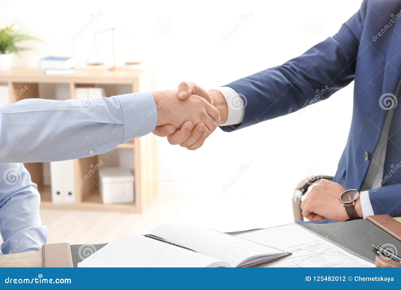 Lawyer Handshaking with Client Over Table in Office Stock Photo - Image ...