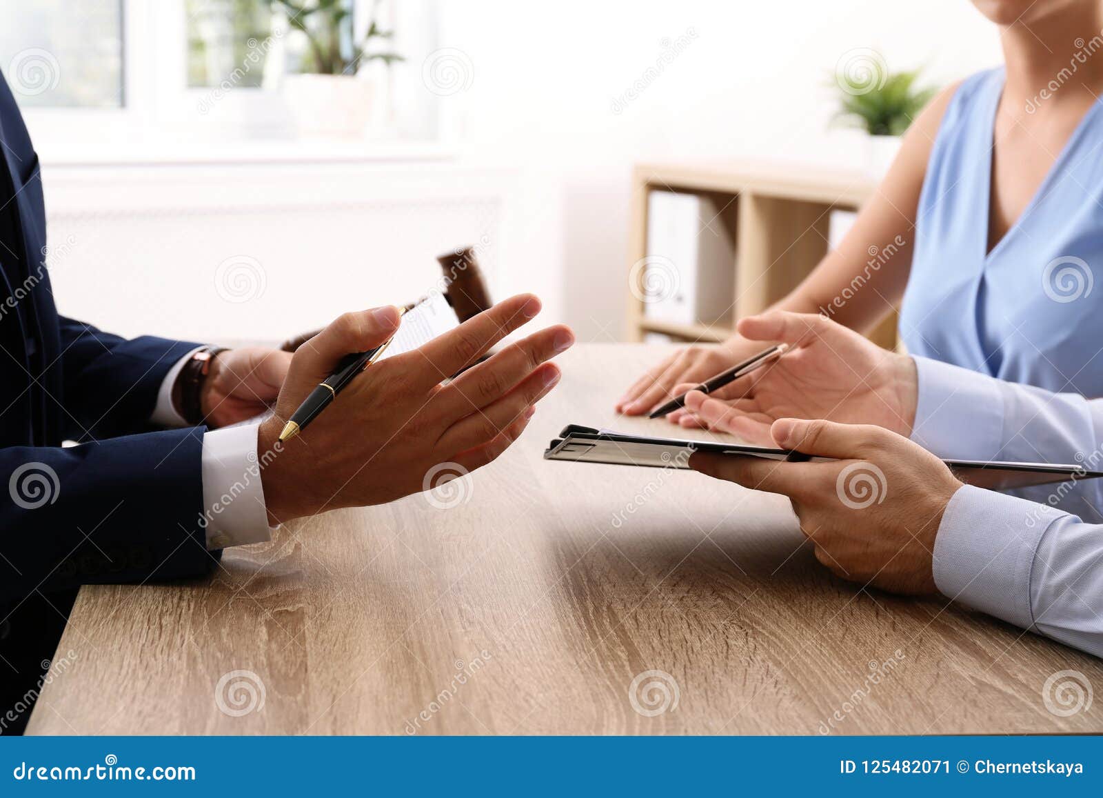 Lawyer Working with Clients at Table in Office, Focus Stock Image ...