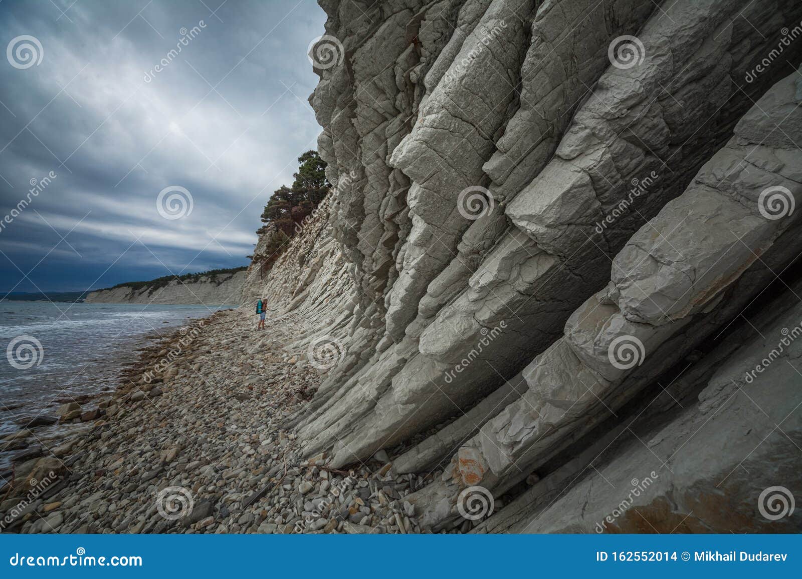 Layered limestone cliffs stock photo. Image of woman - 162552014