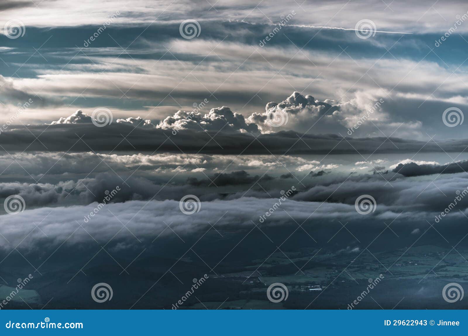 Layers of Clouds in the Evening Sky Above Rolling Hills Landscape Stock ...