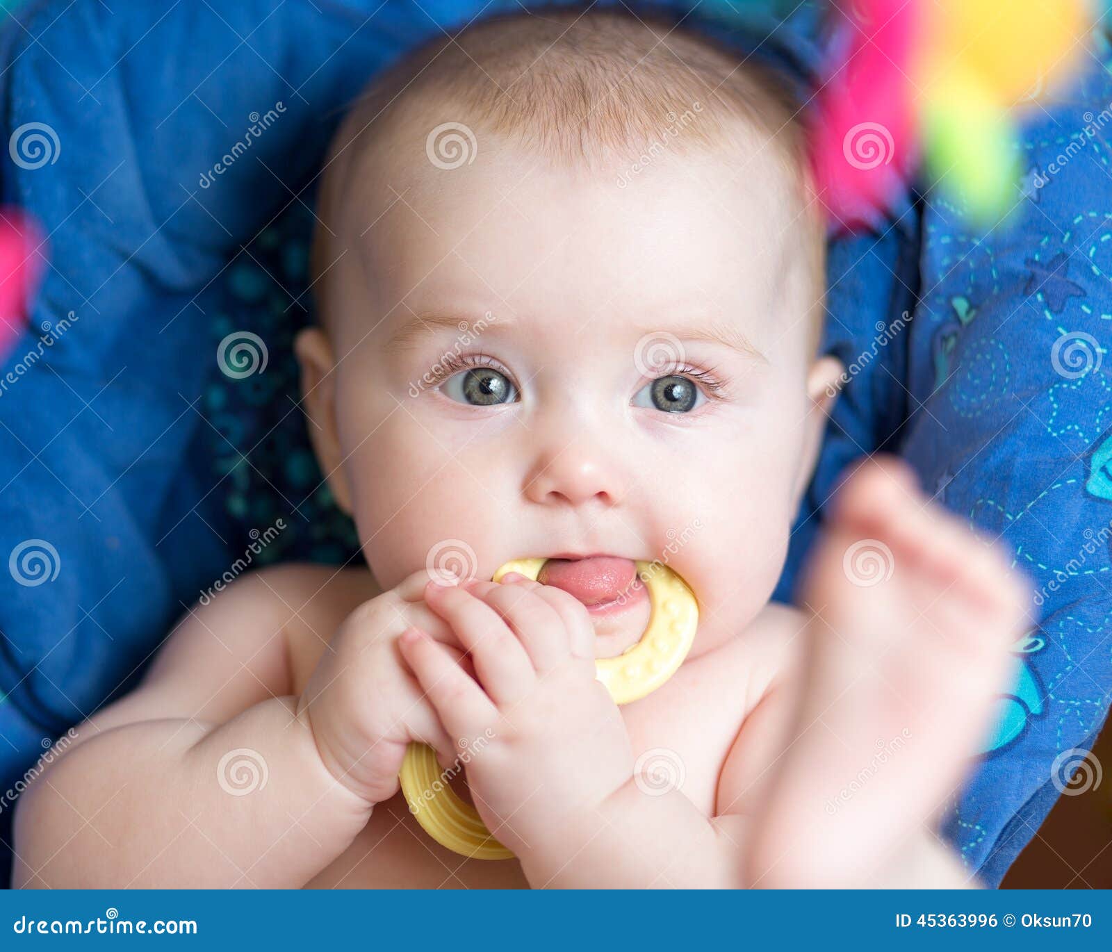 Laying Baby Girl Using Teether Stock Photo - Image of pain, portrait ...