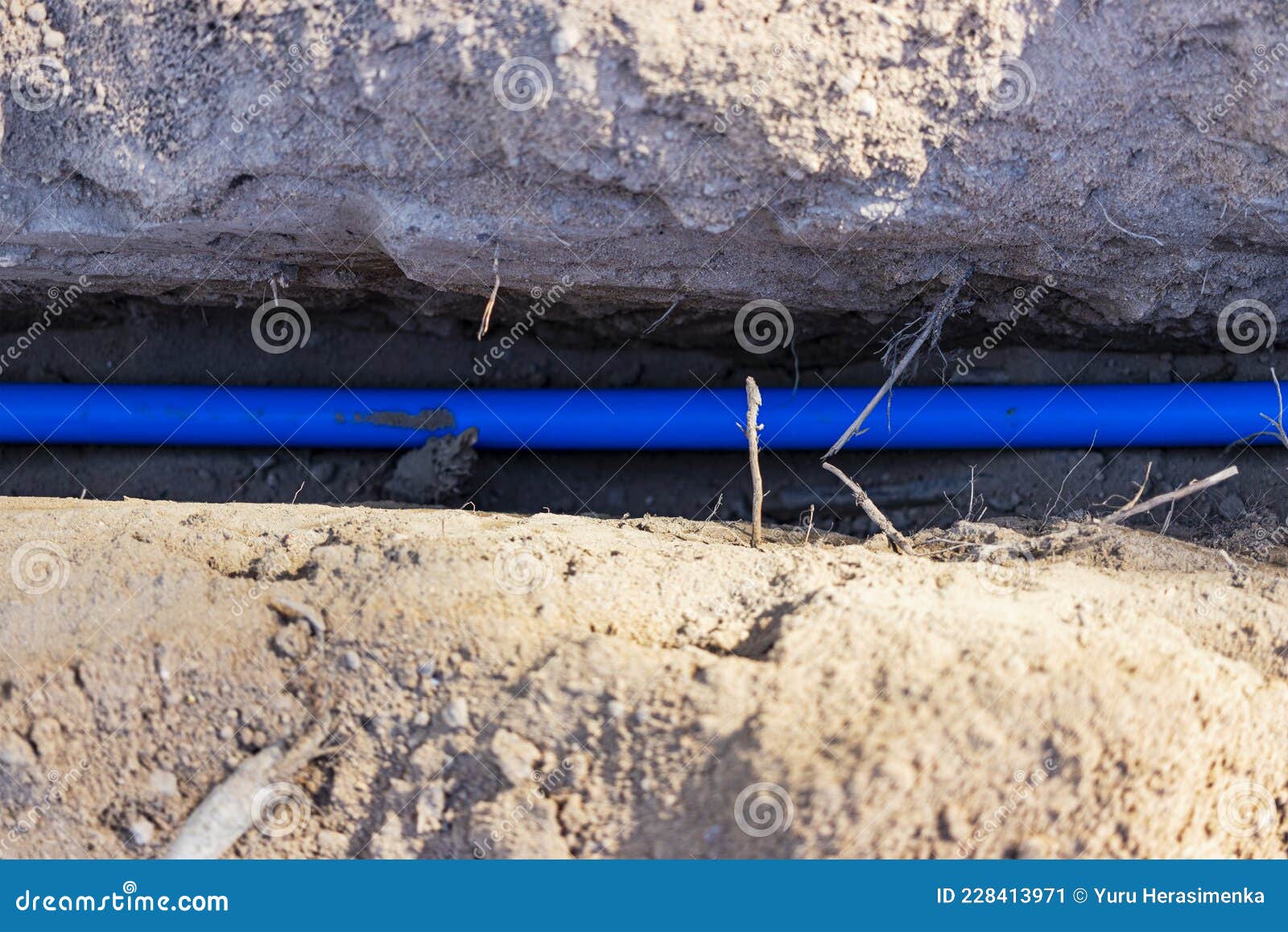 Laying a Blue Electrical Cable in a Trench in the Ground. Underground ...