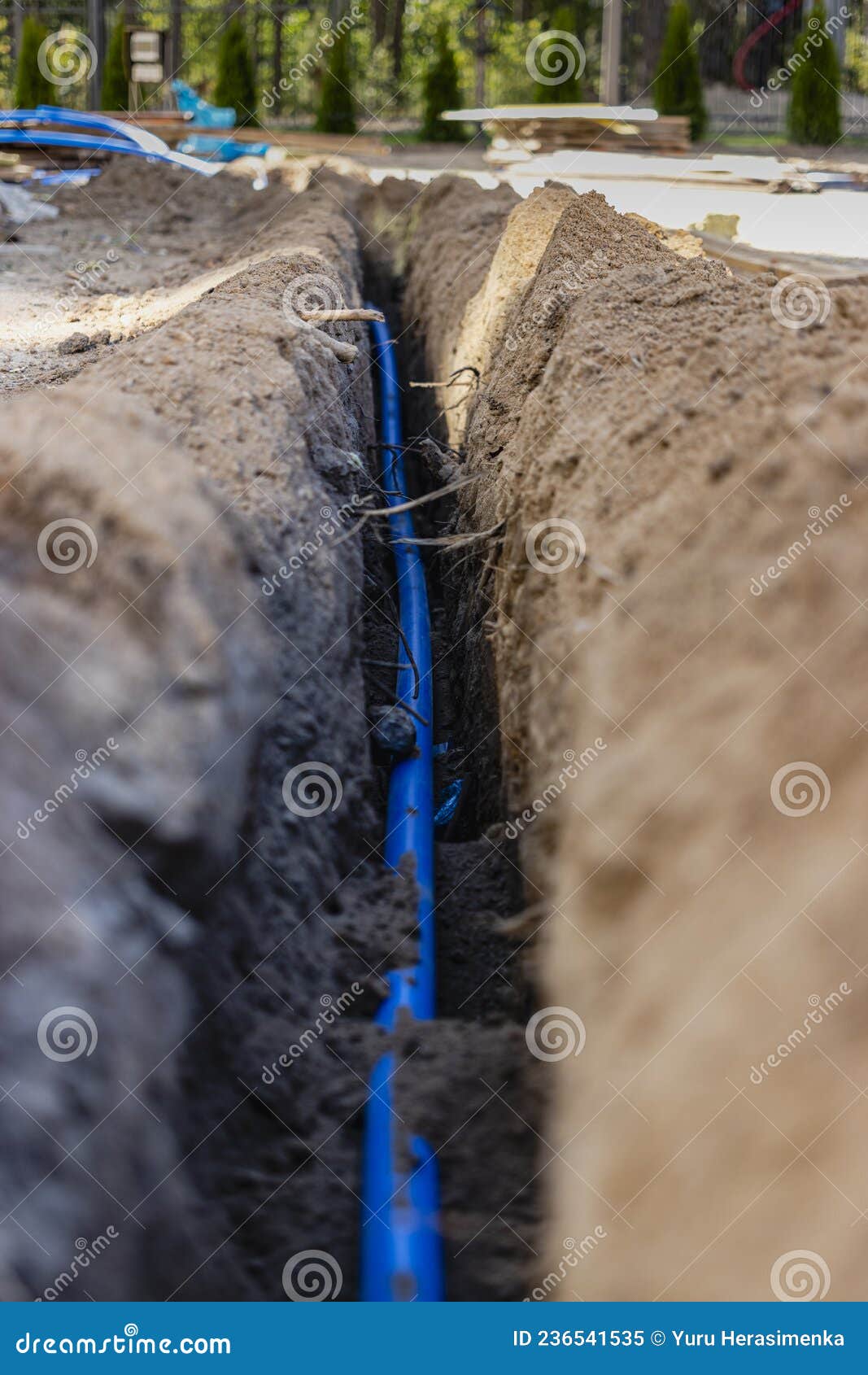 Laying a Blue Electrical Cable in a Trench in the Ground. Underground ...