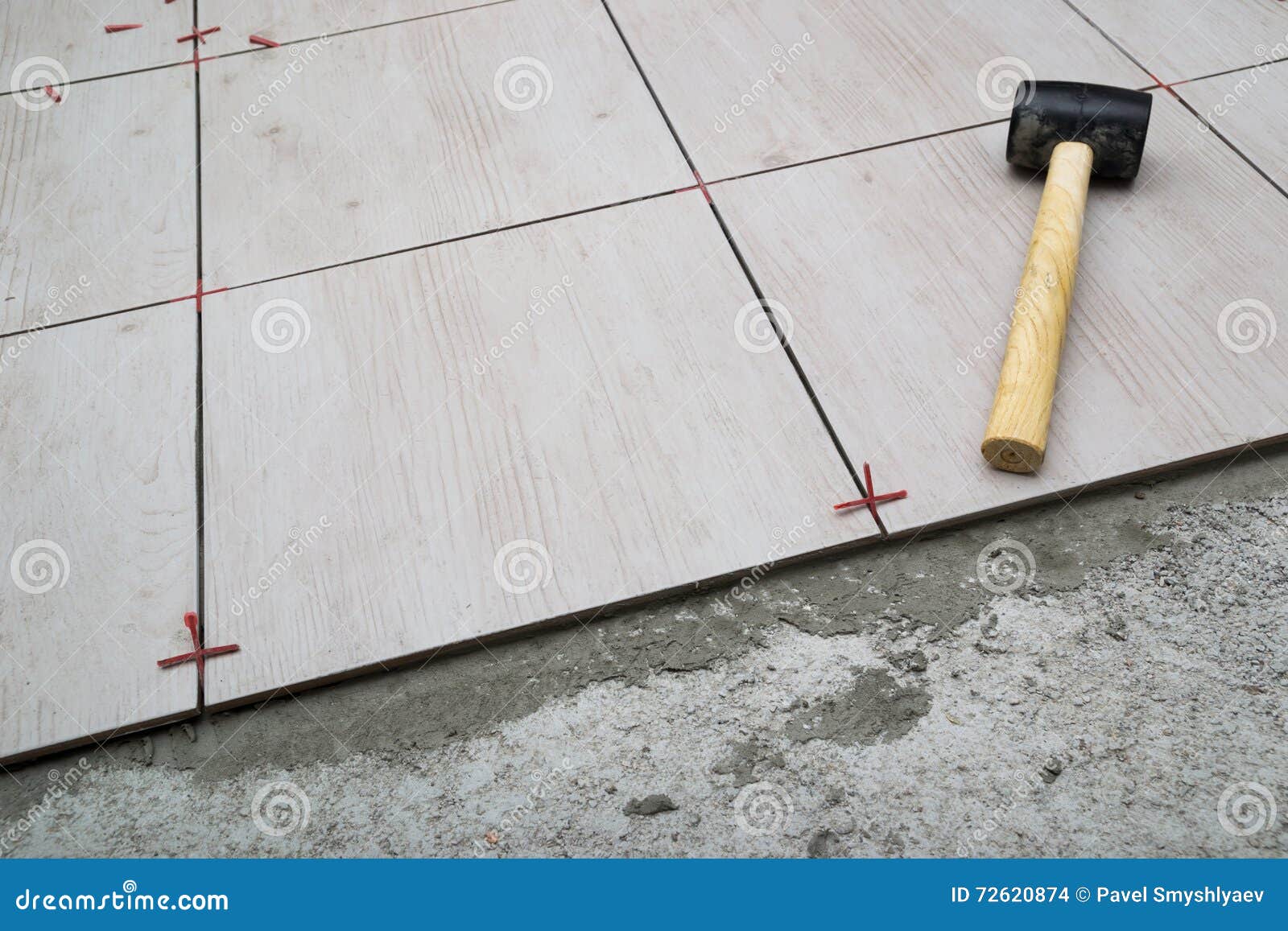 Laying ceramic floor tile stock photo. Image of buildings - 72620874