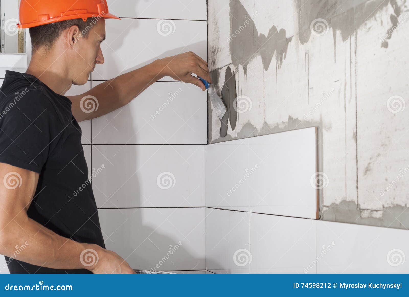 Laying ceramic tiles stock photo. Image of repair, improvement - 74598212