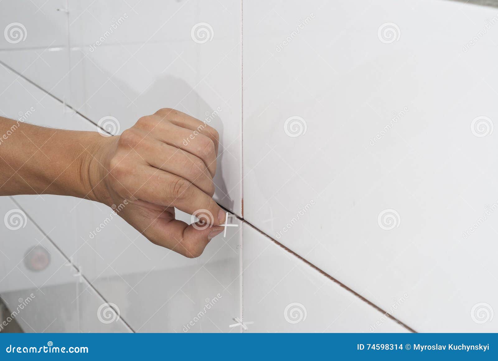 Laying ceramic tiles stock photo. Image of construction - 74598314
